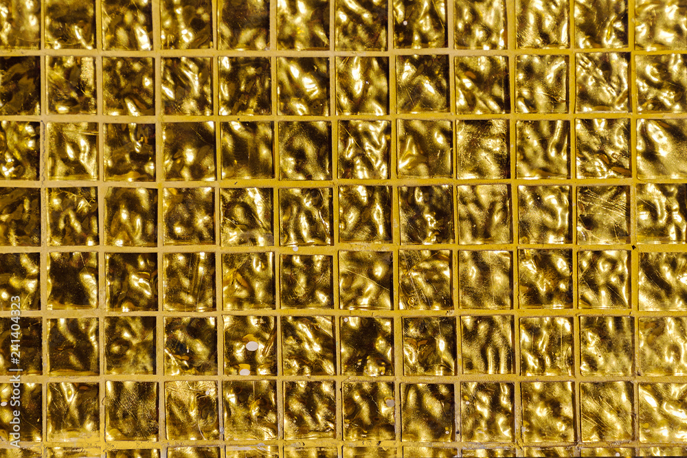 Gold embossed background, square cells. Small golden tile on the wall ...