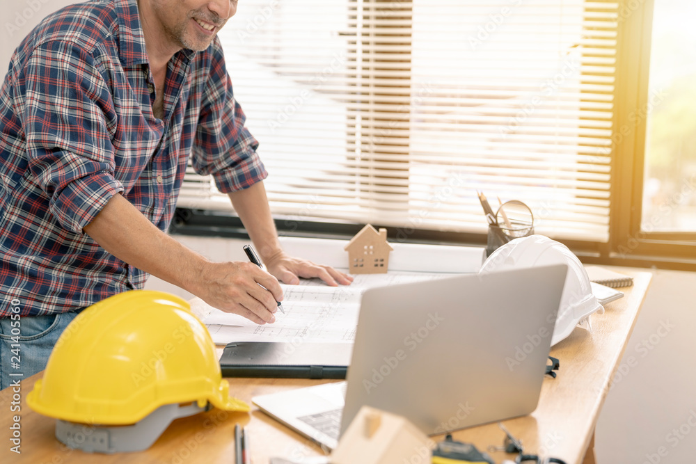 architect or civil engineer during drawing home or building in office ...