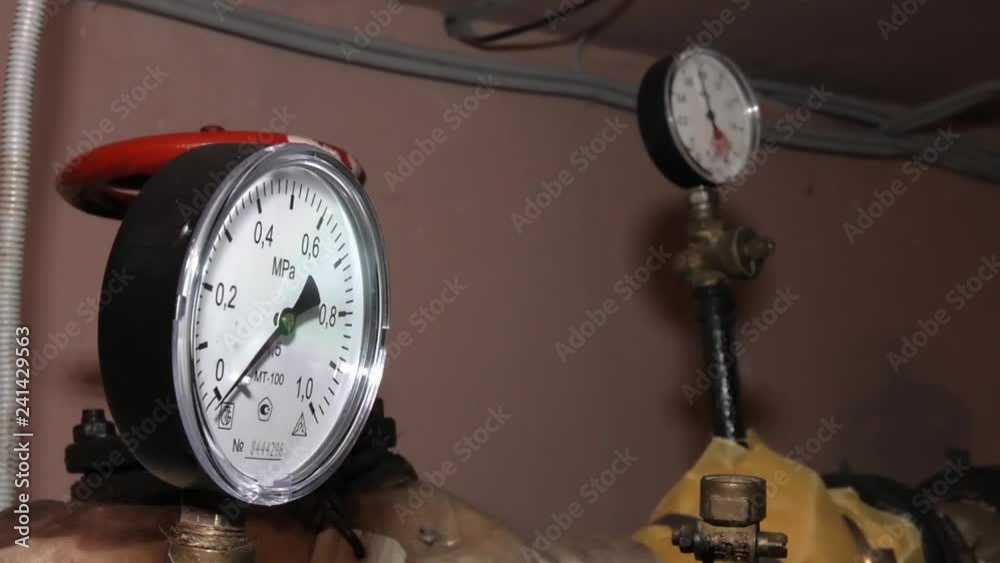 Round mechanical pressure gauges on pipelines. Modern industrial boiler ...