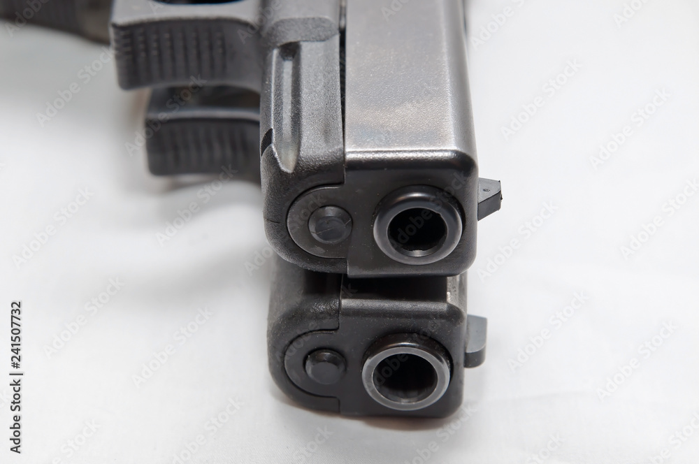 Two black semi automatic pistols, a 9mm and a 40 caliber with one on ...