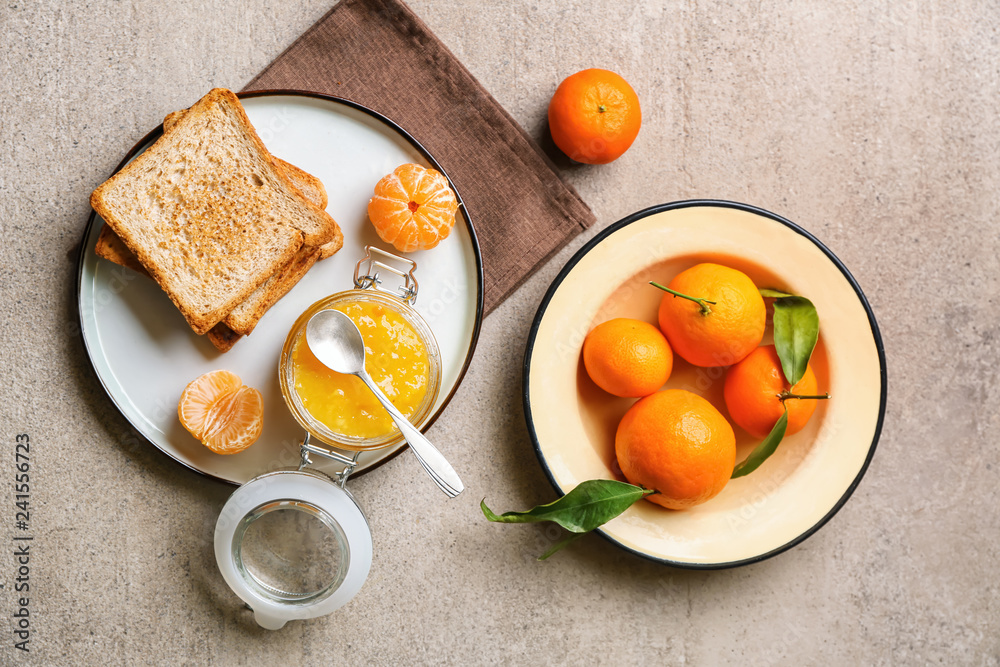Jar of tasty tangerine jam with toasted bread on table Stock Photo ...