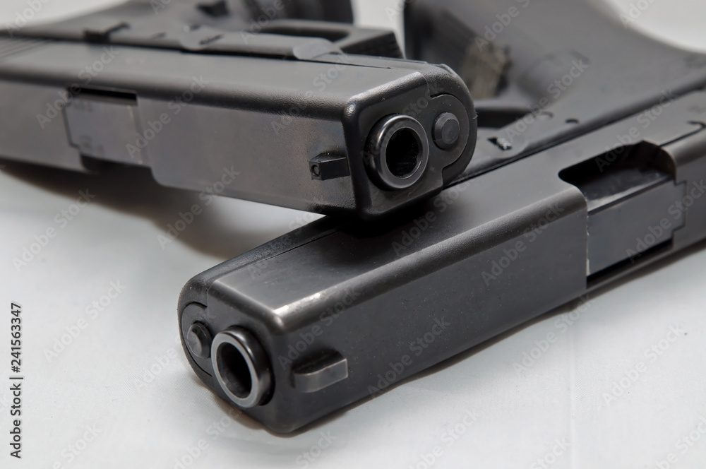 Two black semi automatic pistols, a 9mm and a 40 caliber with one on ...