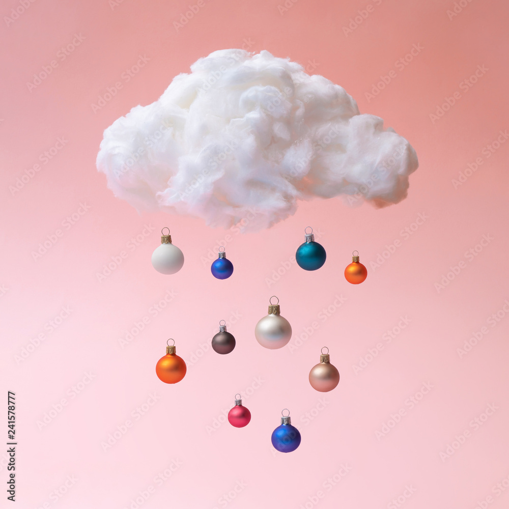 Cloud with Christmas ornaments as rain. Minimal New Year concept ...