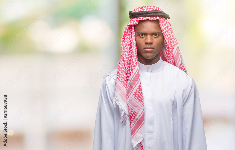 Young arabic african man wearing traditional keffiyeh over isolated ...