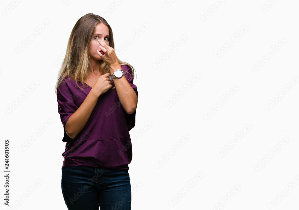 Young beautiful blonde elegant woman over isolated background smelling ...