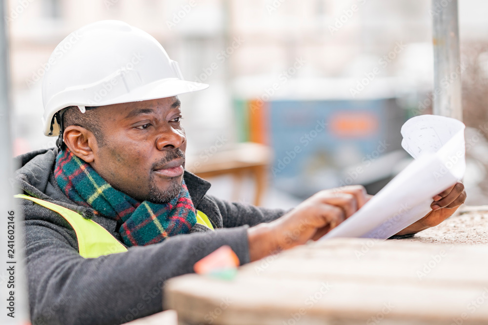 Profile portrait of an absorbed African American male engineer wearing ...
