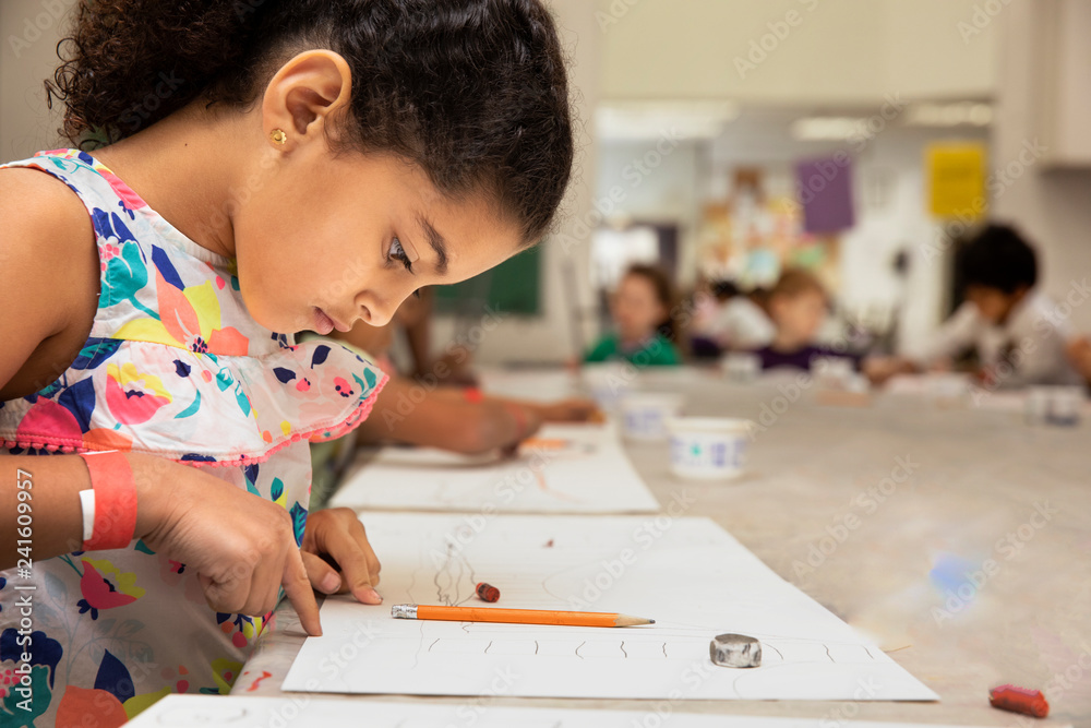 Young girl drawing in a classroom Stock Photo | Adobe Stock