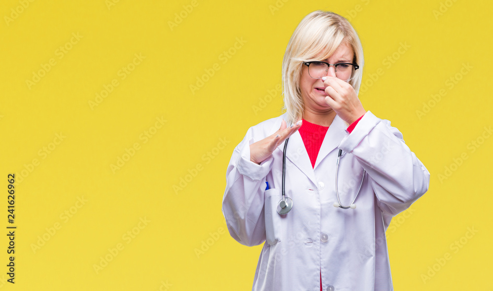 Young beautiful blonde doctor woman wearing medical uniform over ...