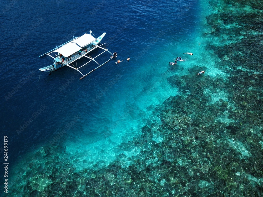 An aerial shot of an island hopping boat around Palawan Islands in the ...