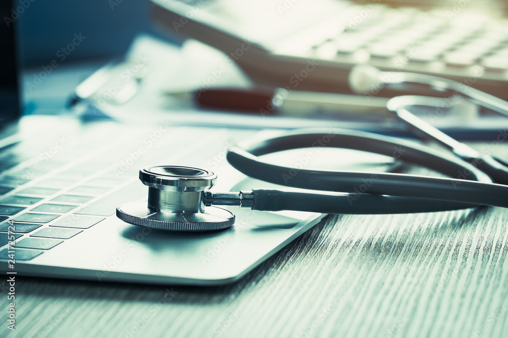 Stethoscope on computer with test results in Doctor consulting room ...