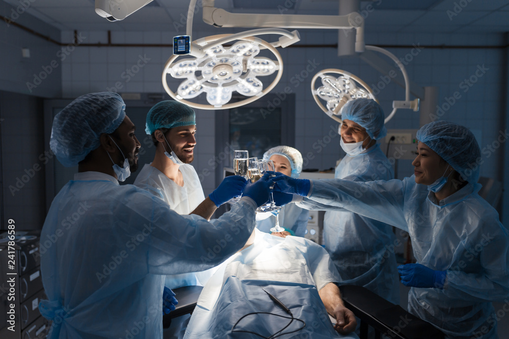 Multiracial happy resuscitation team celebrating New year with glasses ...
