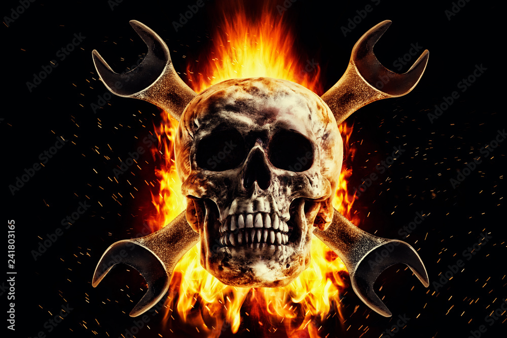 Skull and crescent wrench in a fire, isolated on a black background ...