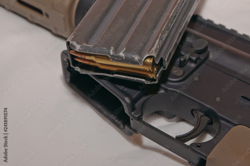 The upper of a black and brown 223 caliber AR-15 rifle with a removed ...