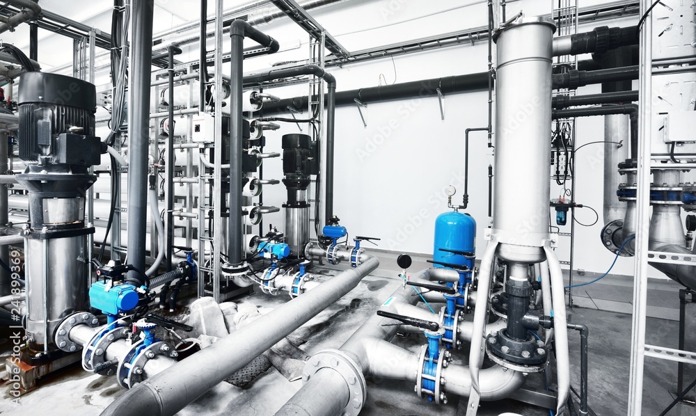 Large industrial water treatment and boiler room. Shiny steel metal ...