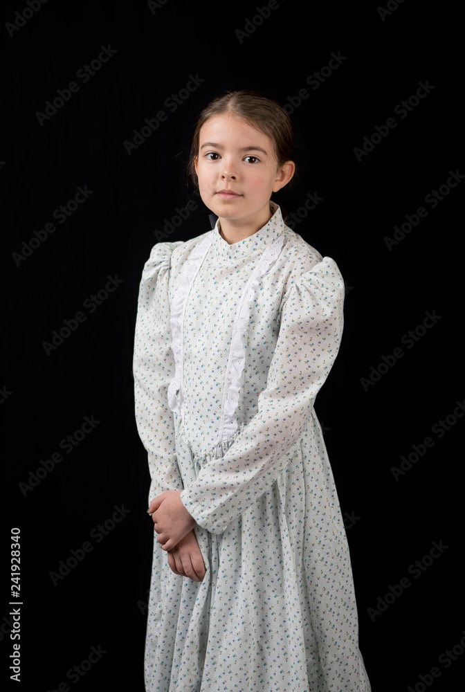 Little girl in vintage clothing, pioneer style clothing and hairstyle ...