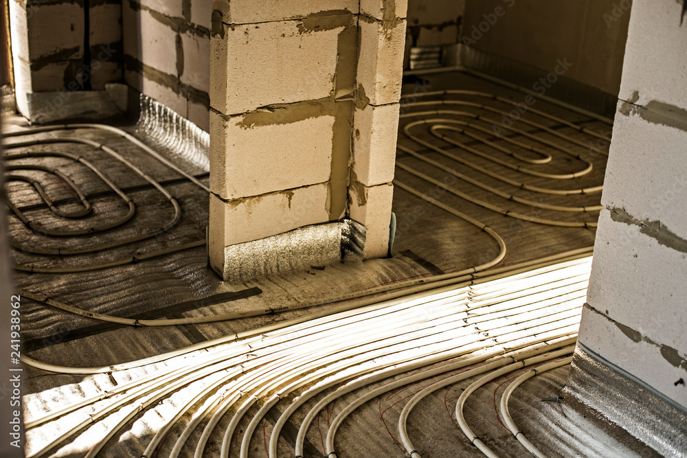 The process of installation of heat flooring in a new building house ...