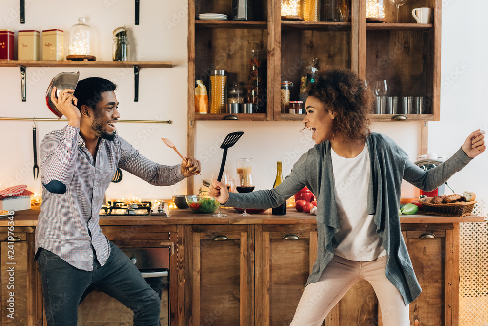 Funny couple fighting with utensils tools in kitchen Stock Photo ...