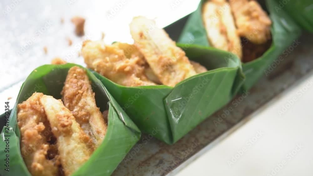 fried banana or kluay khek with nut in tray and banana leaf for dessert ...