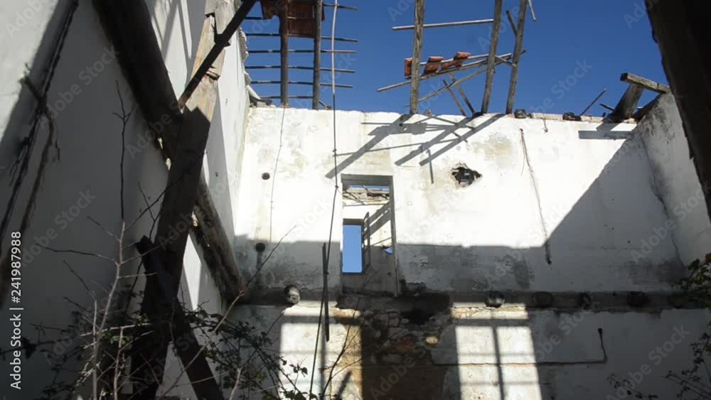 The roof of the school destroyed in the war. Abandoned houses and ...