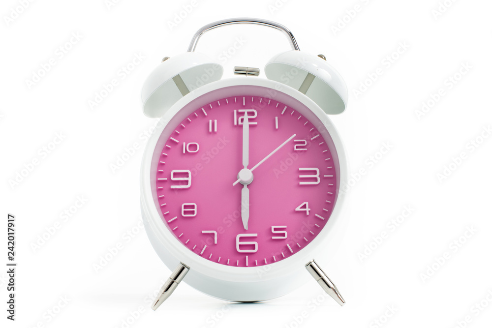 Twin bells analogue alarm clock with pink clock face shows six o’clock ...
