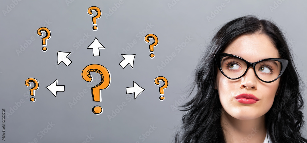 Big and small question marks with arrows with young businesswoman in a ...