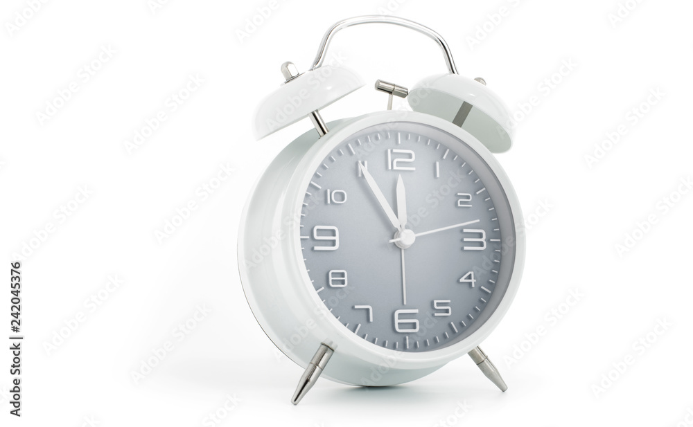 Twin bells analogue alarm clock shows time 5 to 12 with gray clock face ...