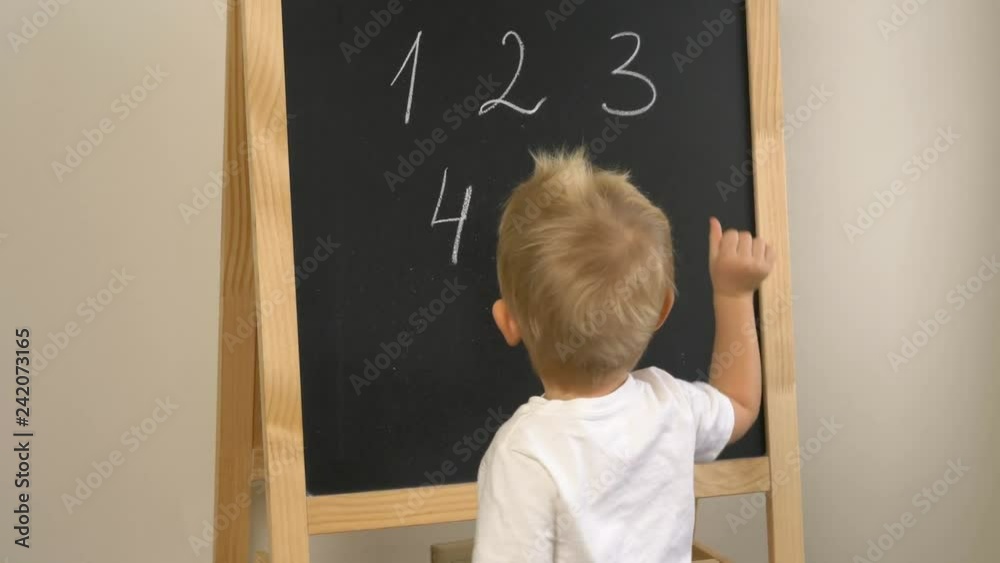 Cute little boy (toddler, two years old) is showing numbers on the ...