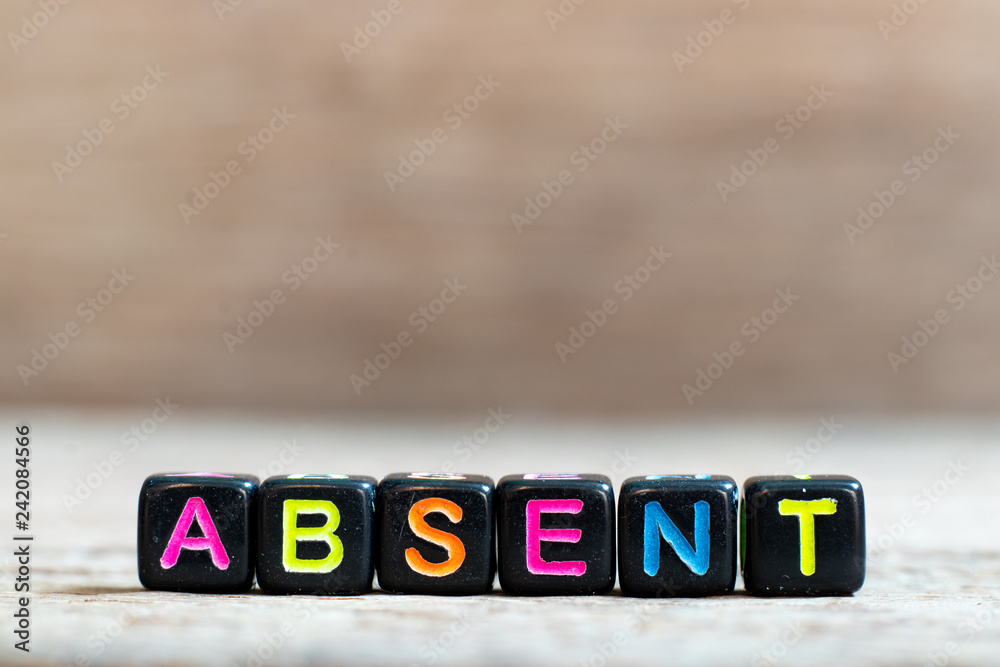 Black bead with color alphabet in word absent on wood background Stock ...