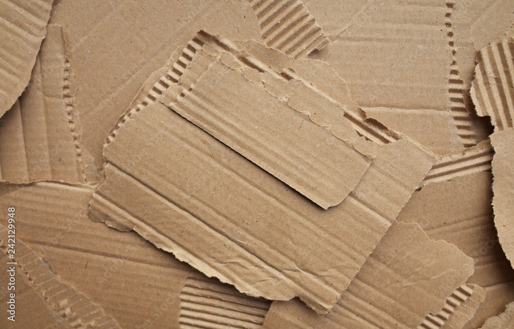 Pieces of torn cardboard paper packaging laid out flat and photographed ...