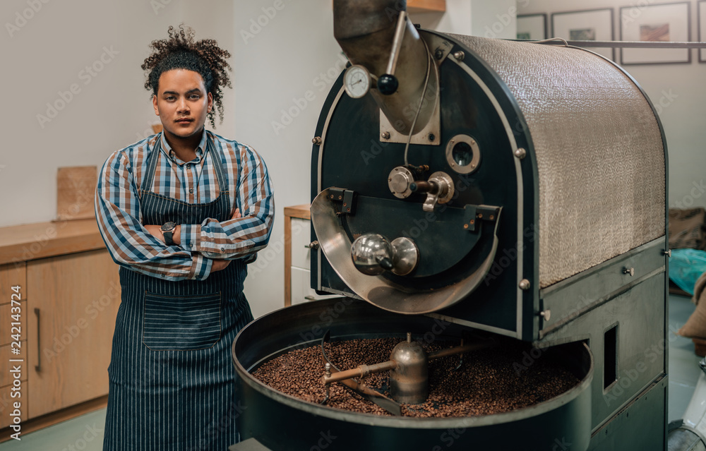 Entrepreneur in his modern well-kept coffee roastery and distribution ...