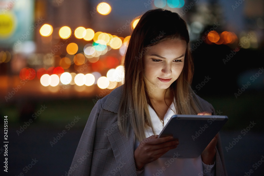 Beautiful woman with tablet outside in the night city Stock Photo ...