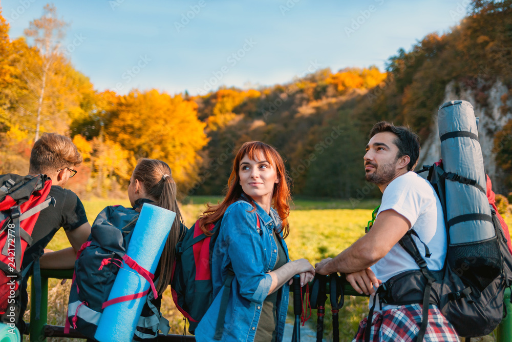 Zdjęcie Stock: Group of friends during a tourist trip with backpacks ...