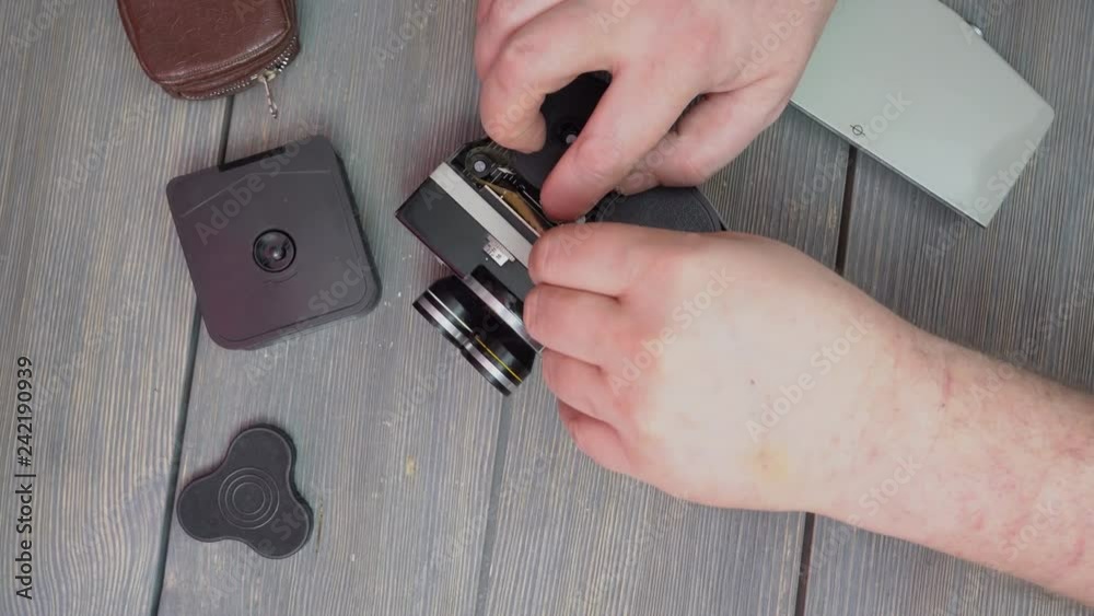 Man using vintage 8mm film movie camera. Loading spool of film into the ...