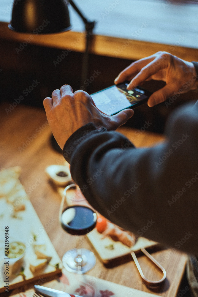 Food blogger making photo of food in restaurant. Photo with grain ...