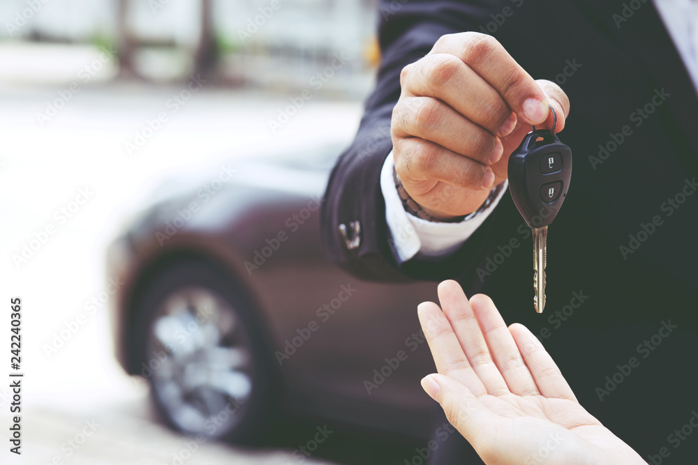 Car key, businessman handing over gives the car key to the other woman ...