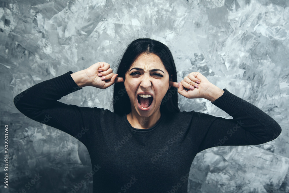 woman covering her ears Stock Photo | Adobe Stock