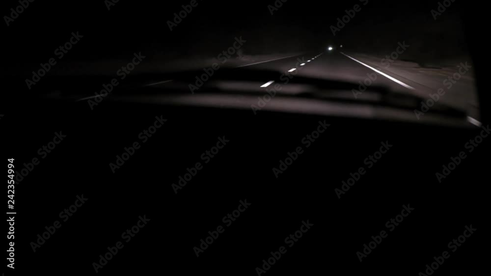 Car rides on the night road. Inside view. Dashboard, radio, DVR ...