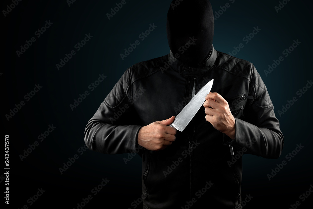 The serial killer, a maniac with a knife and a black chuolkom on his ...