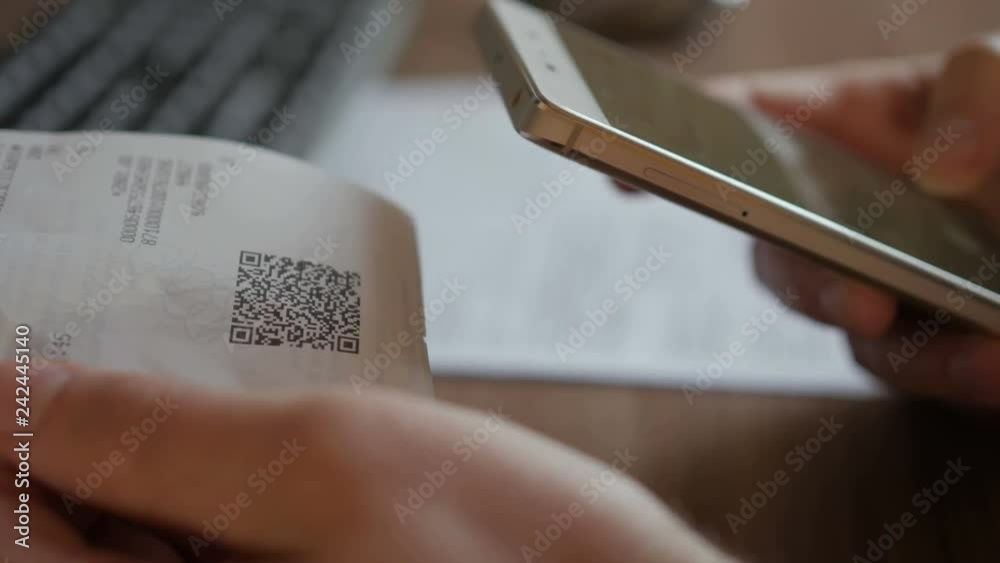 A man scans the QR code on a check from a supermarket. Stock ビデオ ...