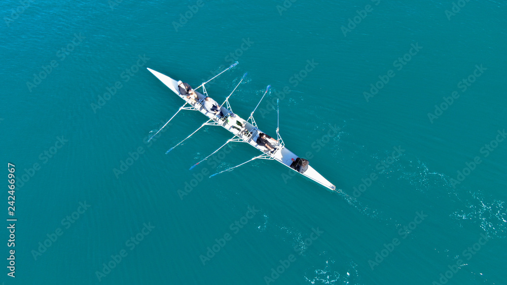 Aerial drone bird's eye view of sport canoe operated by team of young ...