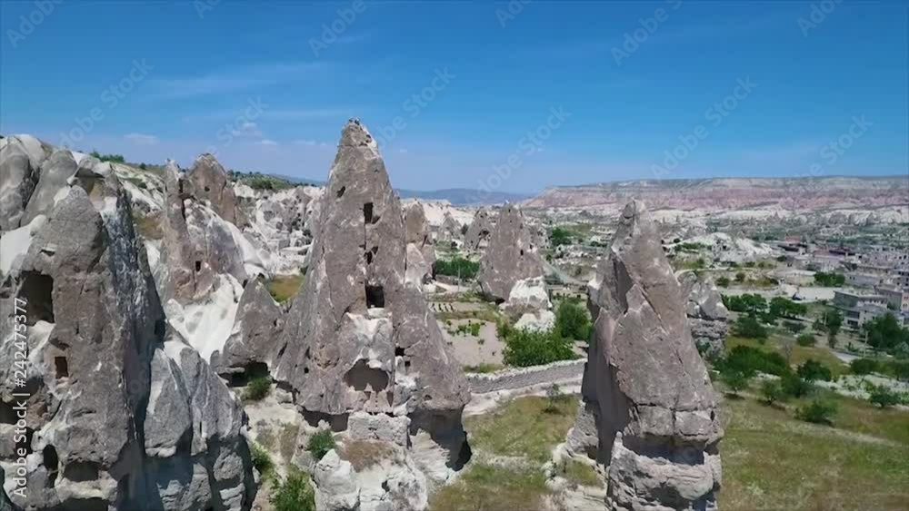 Aerial perspective flying upwards to show peak of tall, pointed rocks ...