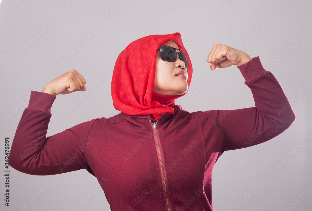 Muslim Lady in Red Shows Strong Muscle Gesture Stock Photo | Adobe Stock