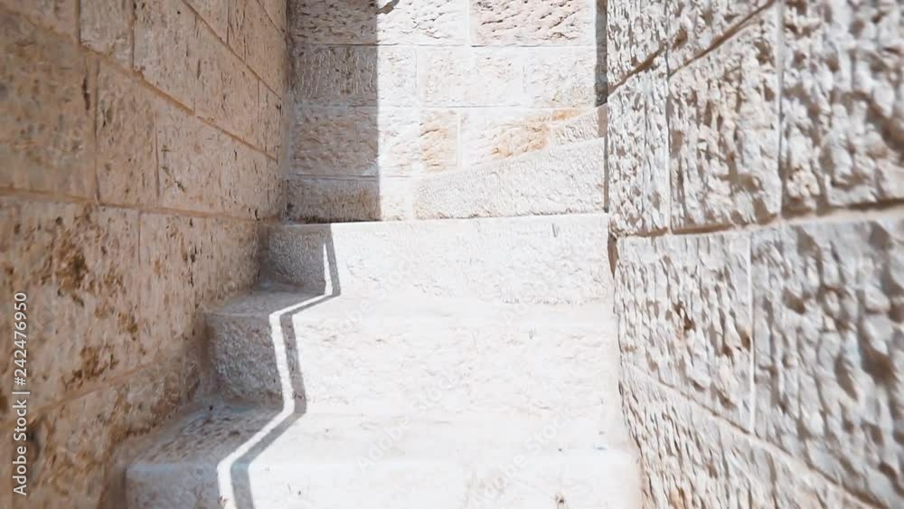 Climbing the ancient stone stairs in the maze of the streets of the old ...
