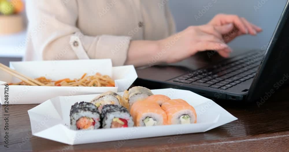 Woman tasting asian food at workplace, takeaway delivery service ...