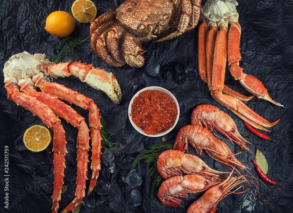 Set of seafood: red and black caviar, limb of hairy crab, limb of snow ...