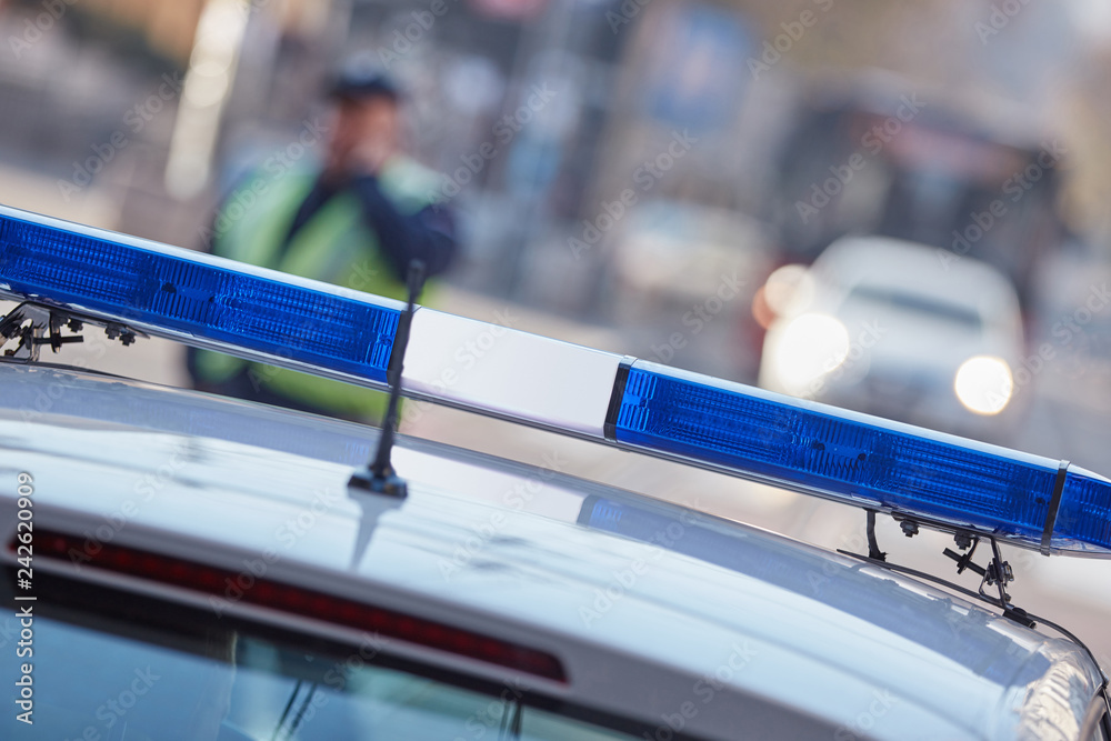 Police car with blue lights on the crime scene in traffic / urban ...