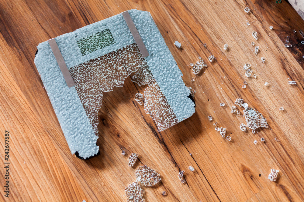 Broken digital human scale on the floor. Broken glassy digital scale ...