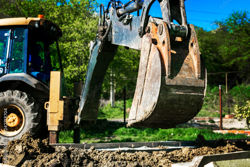 Excavator used for pipe laying works. Digging a trench using a dump ...