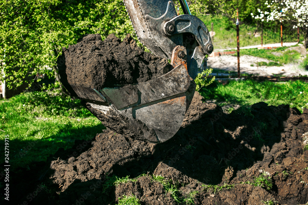 Excavator used for pipe laying works. Digging a trench using a dump ...