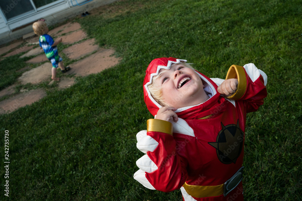 Boy in superhero costume standing outdoors Stock Photo | Adobe Stock